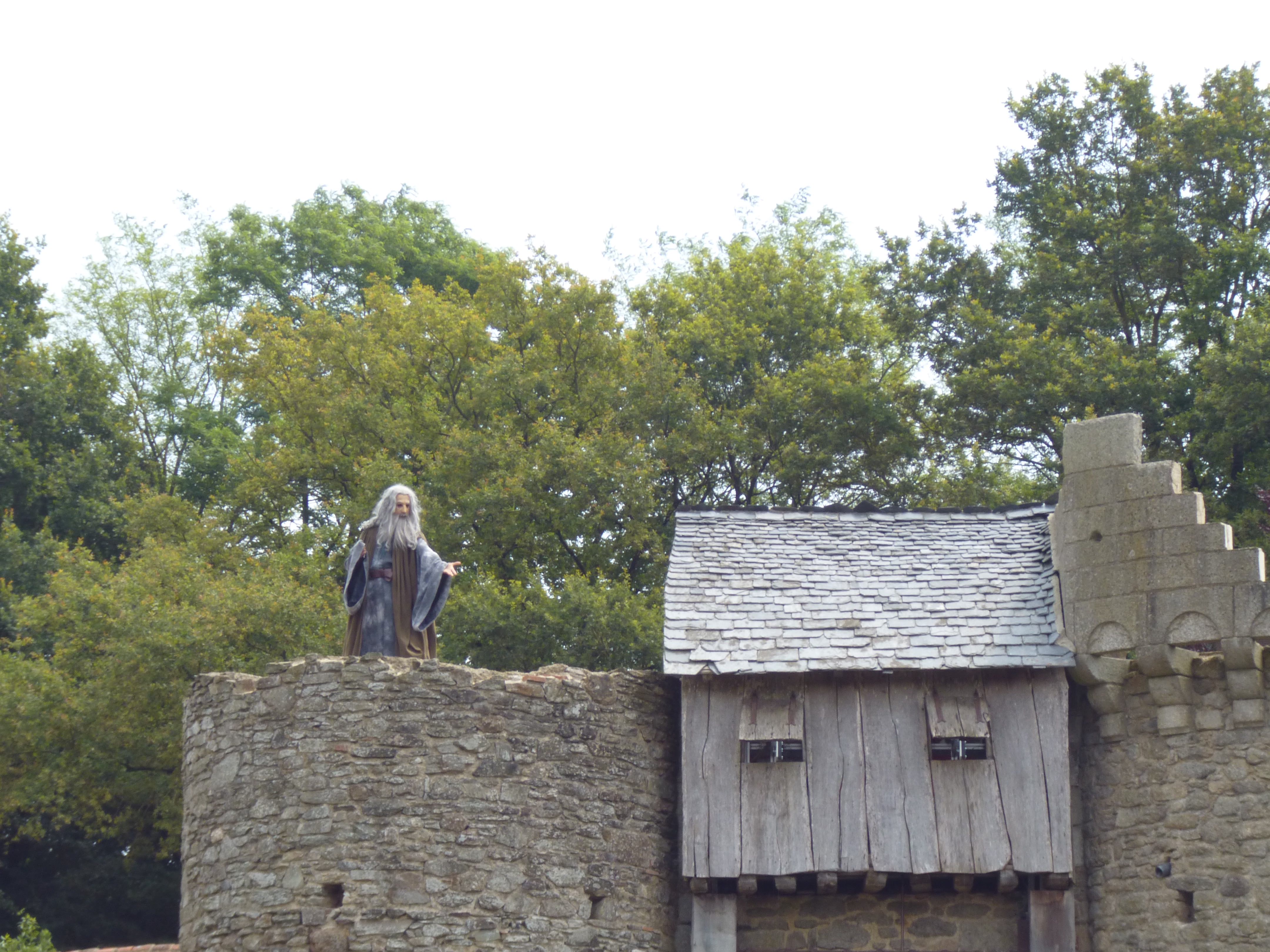 Merlin appears at the top of a castle at Puy du Fou in the Knights of ...